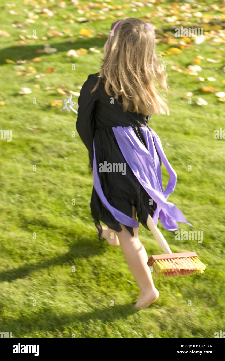Girls, witch's costume, broom, ride, back view Stock Photo - Alamy