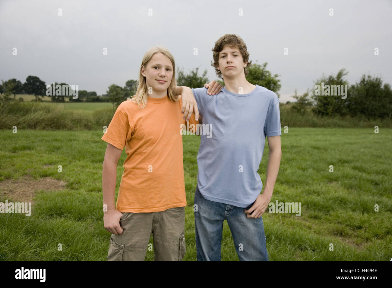 Boys, teenagers, two, meadow, stand, side by side, arm in arm Stock ...