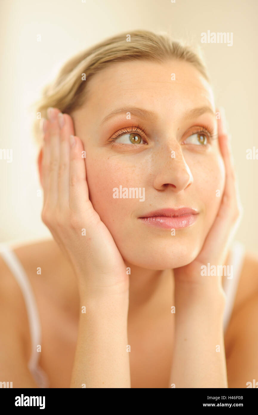 Young woman with hands on head Stock Photo - Alamy