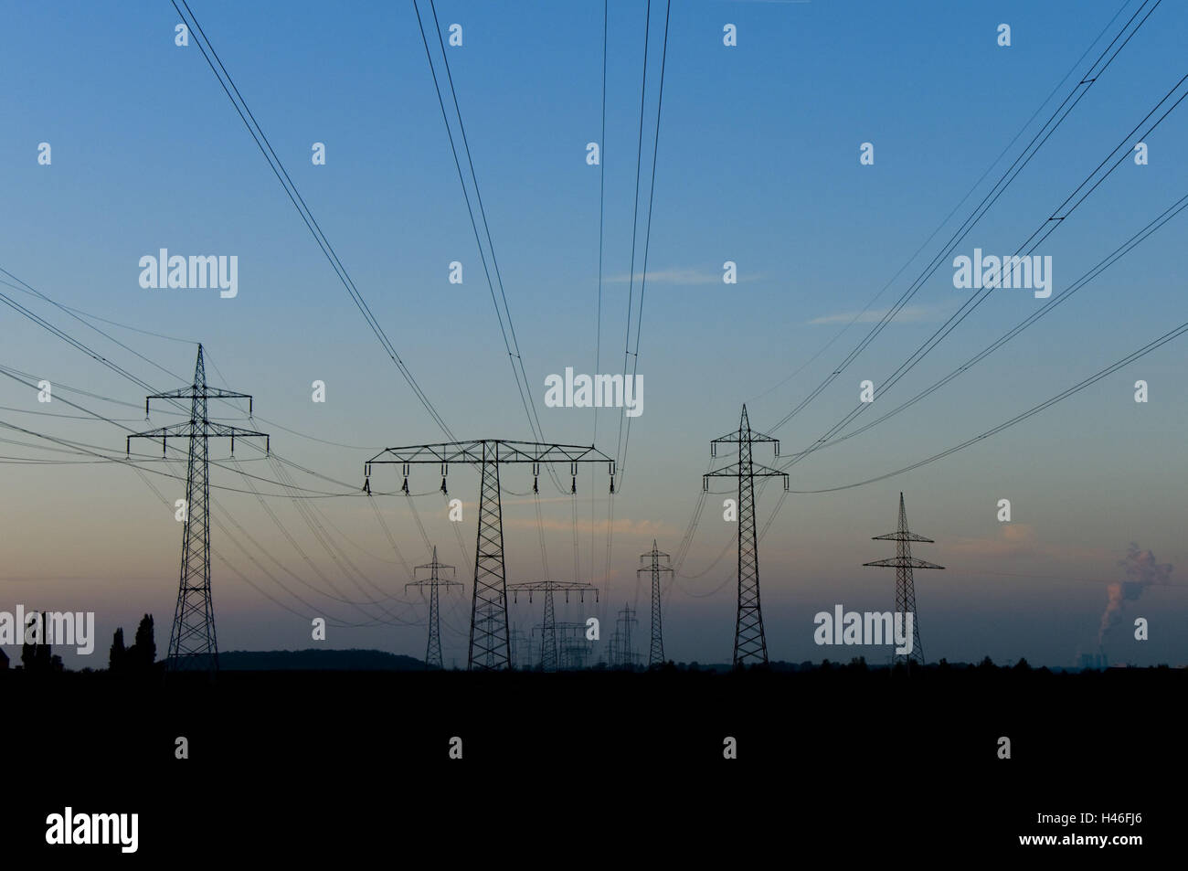 several high-tension power lines in front of evening sky Stock Photo ...