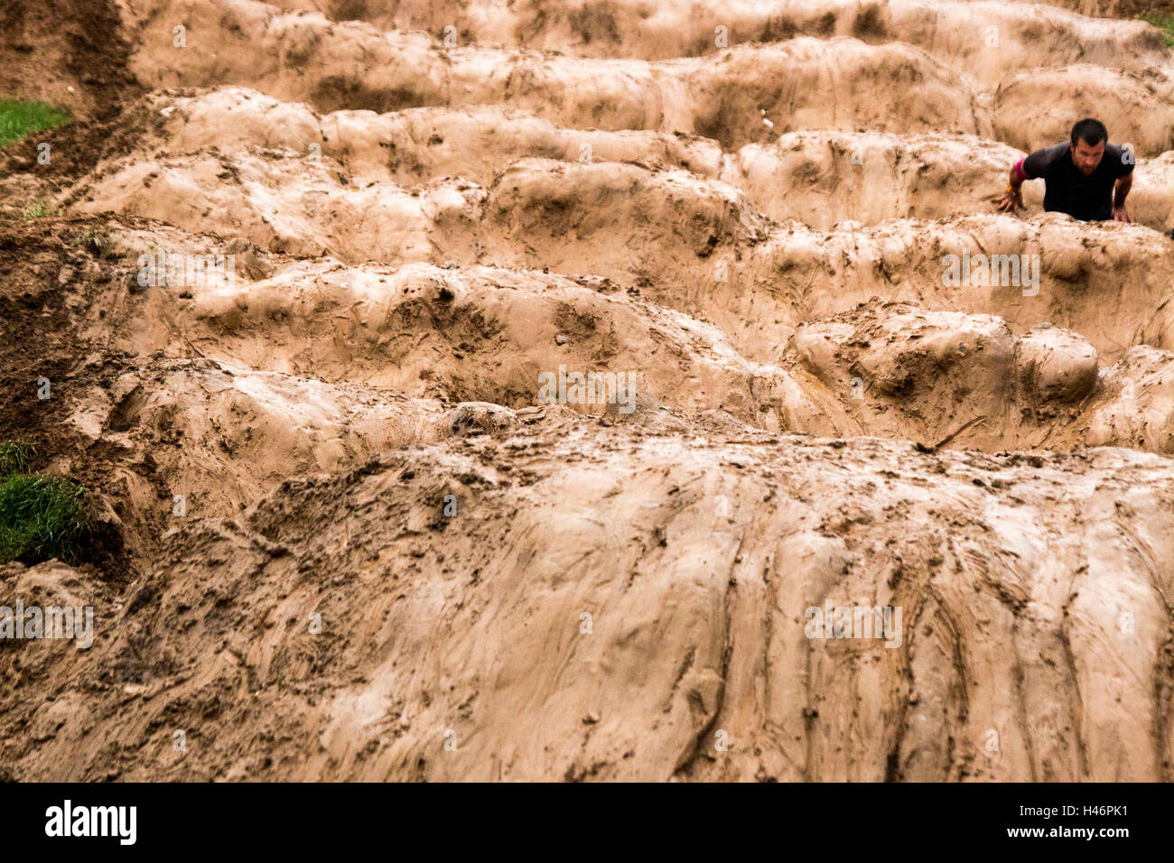 Tough Mudder competitor at an obstacle going through the Mud Mile 2.0 ...