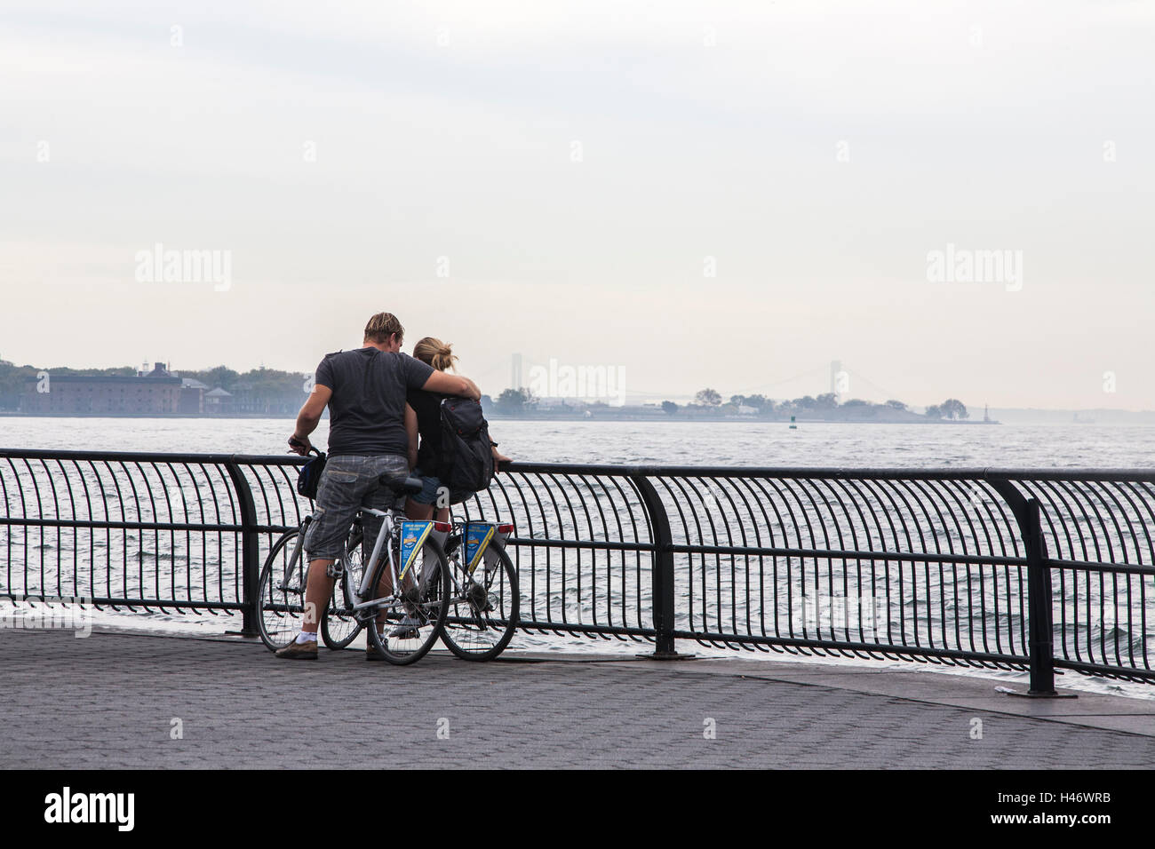 Couple Resting during bike ride along river Stock Photo - Alamy