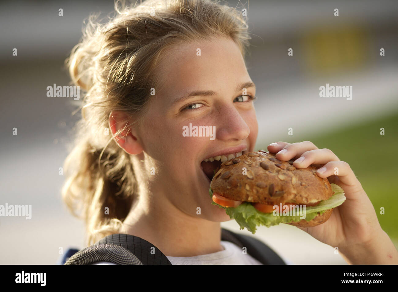 Girls, bread rolls, eat, bite off, view camera, portrait Stock Photo ...