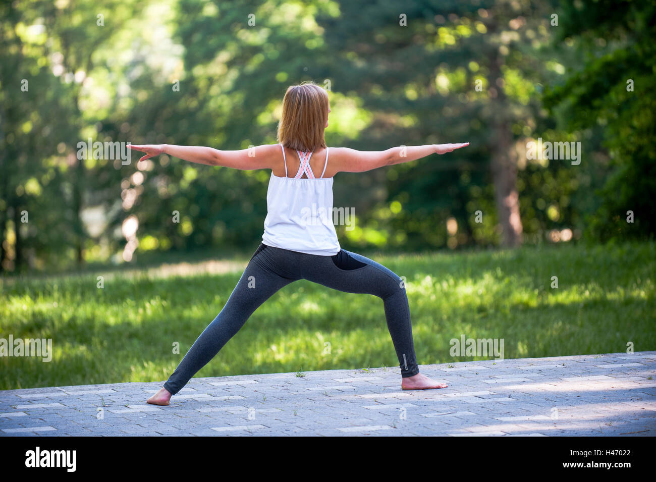 Woman doing yoga exercises Stock Photo - Alamy