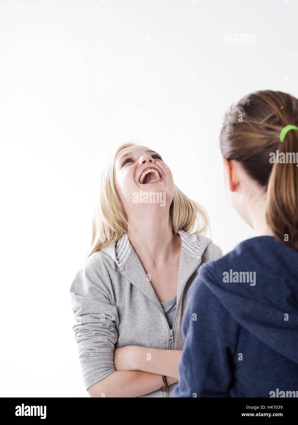 Teenage girls, conversation, laugh, fun, studio Stock Photo - Alamy