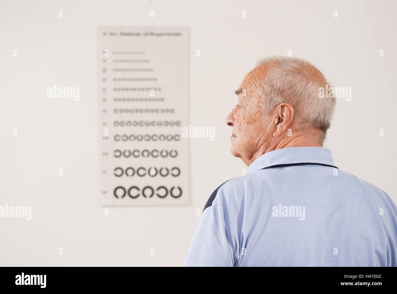 Senior man with the visual test Stock Photo - Alamy