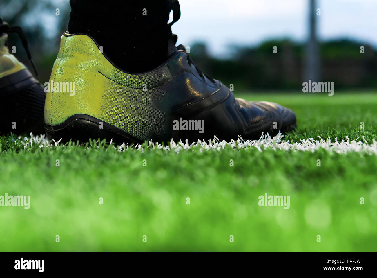 foot of a soccer player or football player on green grass Stock Photo ...