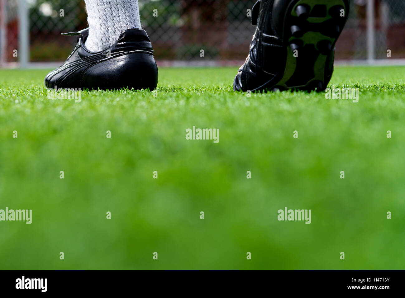 Foot of soccer player or football player walk on green grass ready to ...