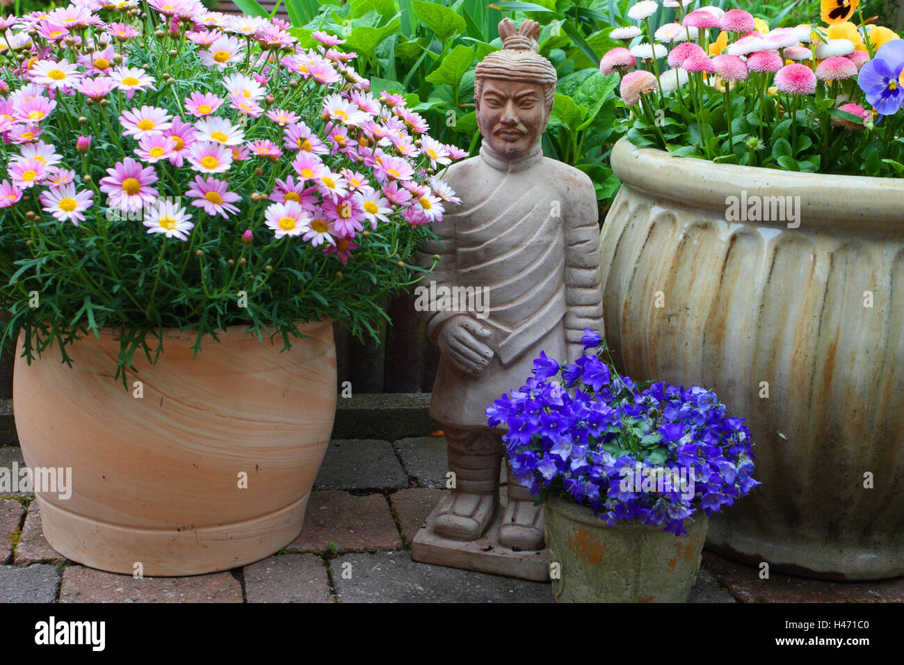 Garden with flowers and garden figure Stock Photo - Alamy