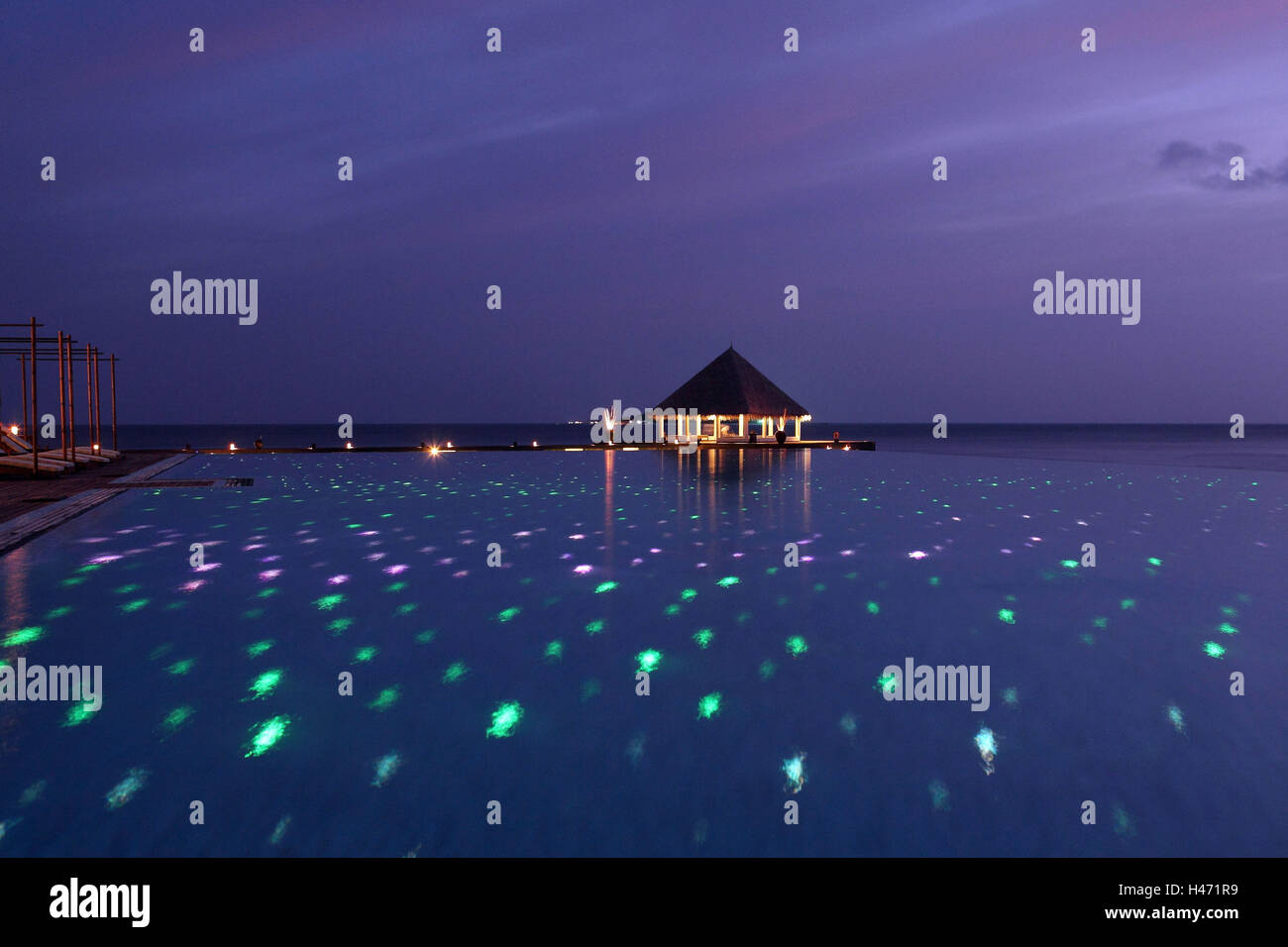 illuminated swimming pool, the Maldives, Indian Ocean, evening light ...