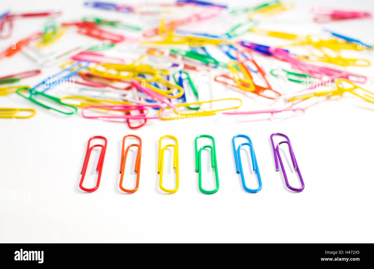 Many colorful paper clips on white background Stock Photo - Alamy