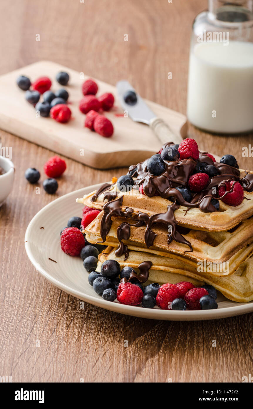 Belgian waffles with fruit and chocolate, forest fruit, all homemade, delicious batter Stock ...