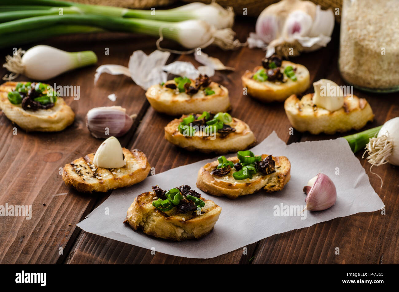 Mini toasts with garlic and dried tomato, sprinkled with herbs Stock ...