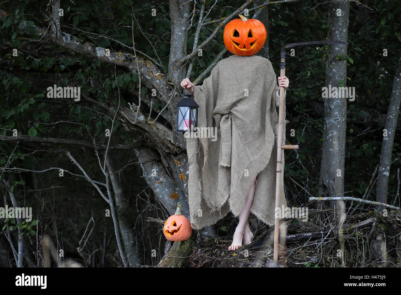 horror pumpkin with a scythe Stock Photo - Alamy