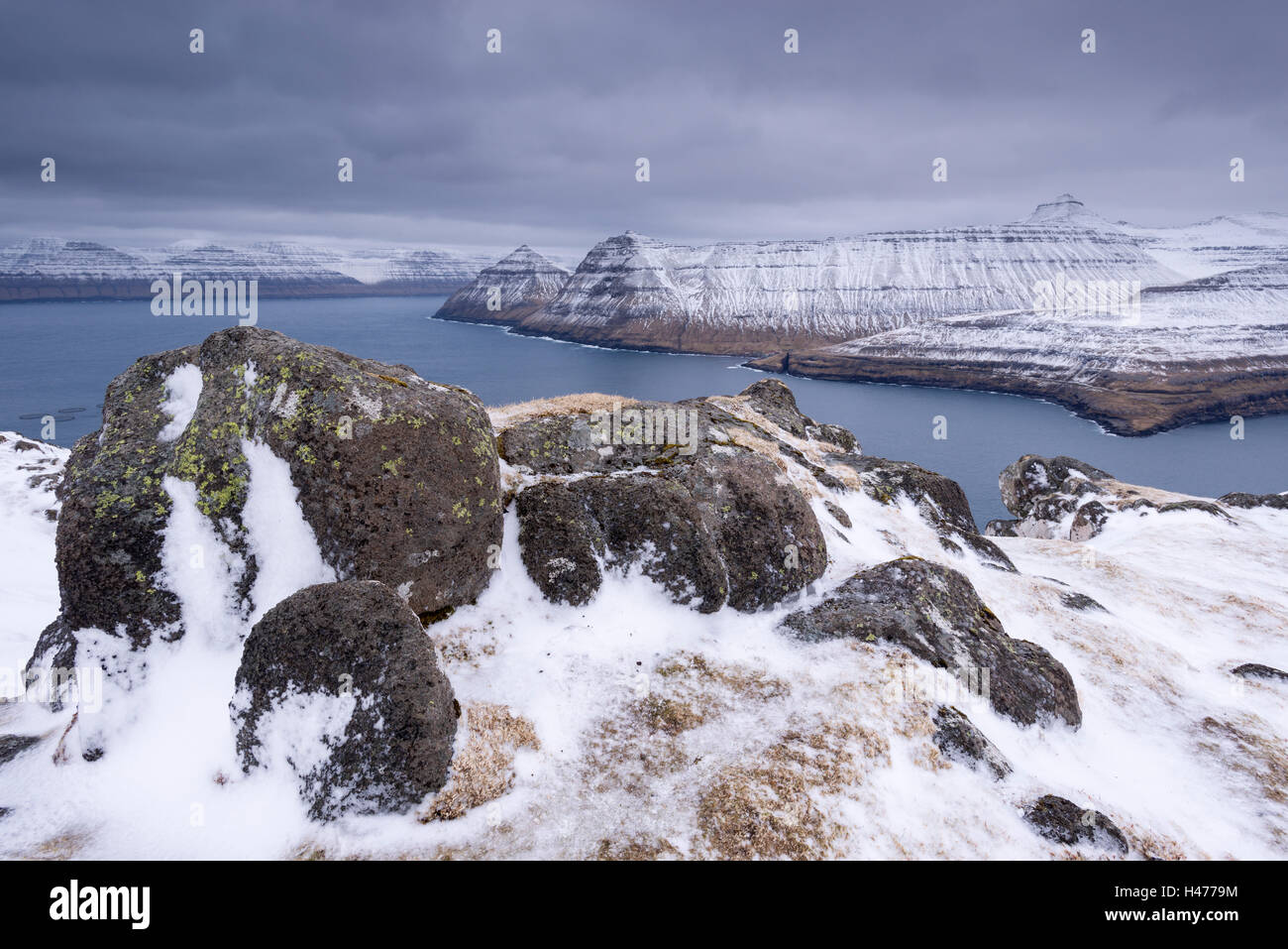 Dramatic snow covered mountain scenery above Funningsfjordur in the ...