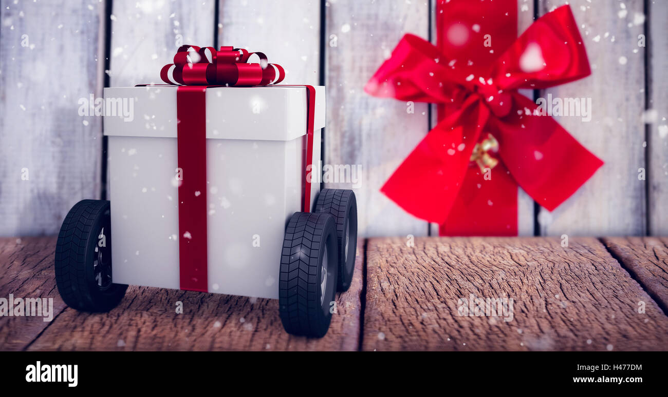 Composite image of gray gift box with wheels Stock Photo - Alamy