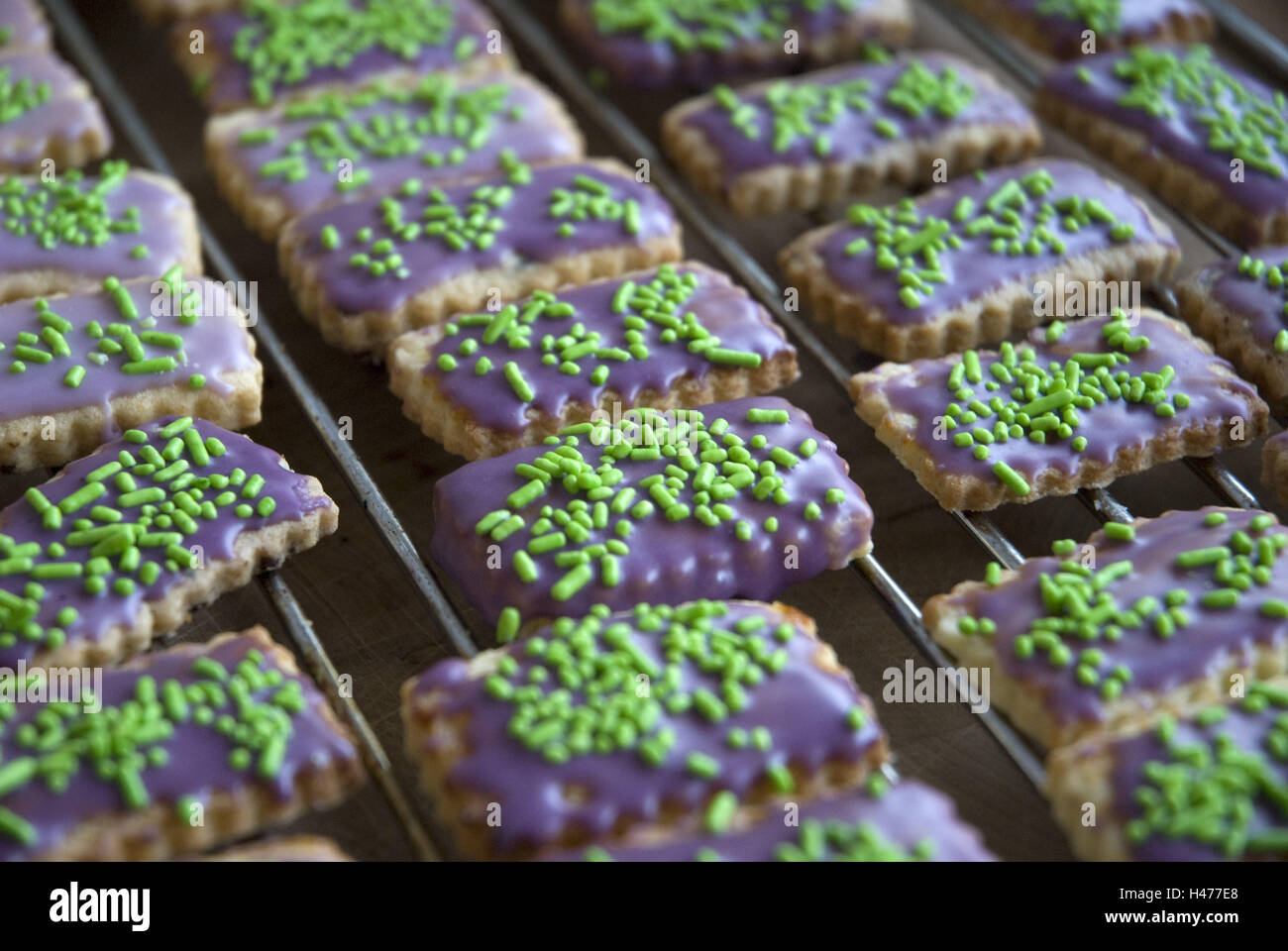 Coloured biscuits on cake grid Stock Photo - Alamy