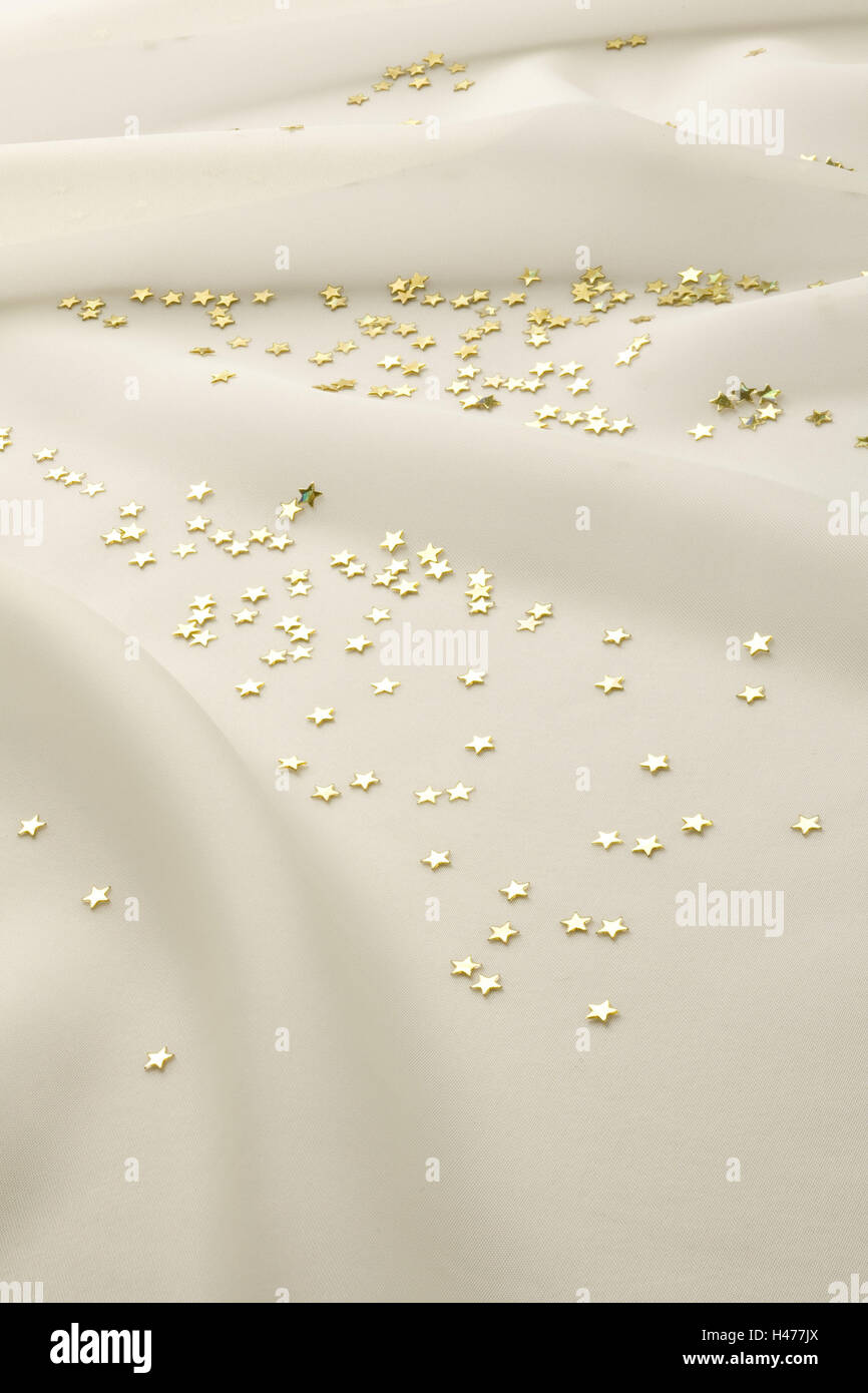 Golden litter stars on white substance Stock Photo - Alamy