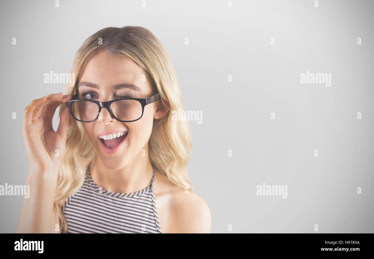 Composite image of gorgeous blonde hipster winking Stock Photo - Alamy