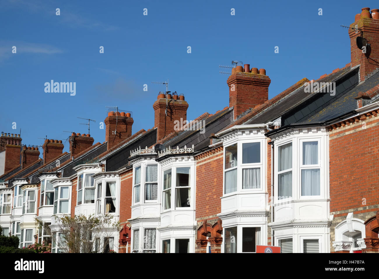 terraced brick houses with bay windows Stock Photo - Alamy