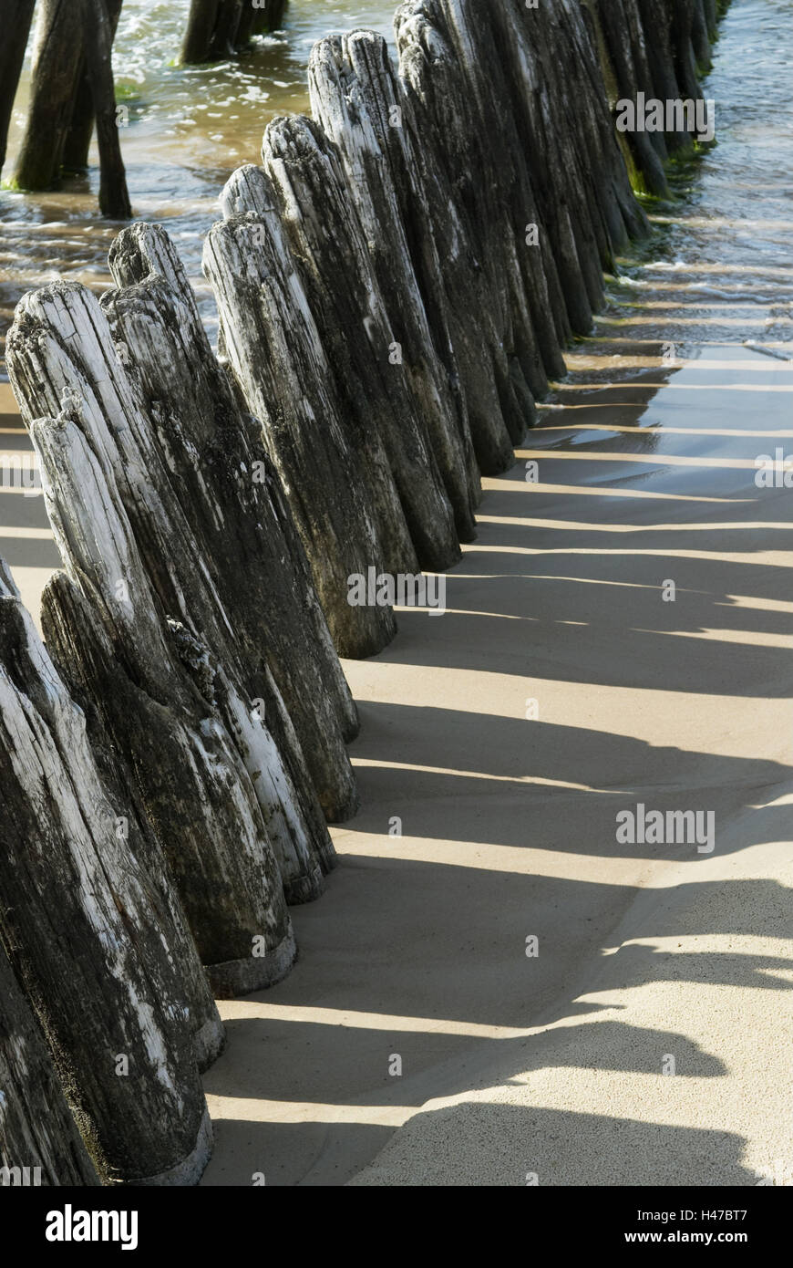 Breakwater, poles, shades, Sand, water Stock Photo - Alamy