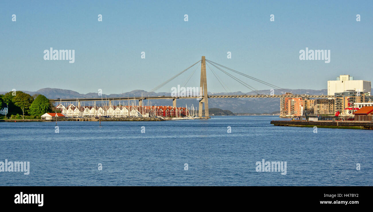 The famous Stavanger suspension bridge with typical white wooden houses ...
