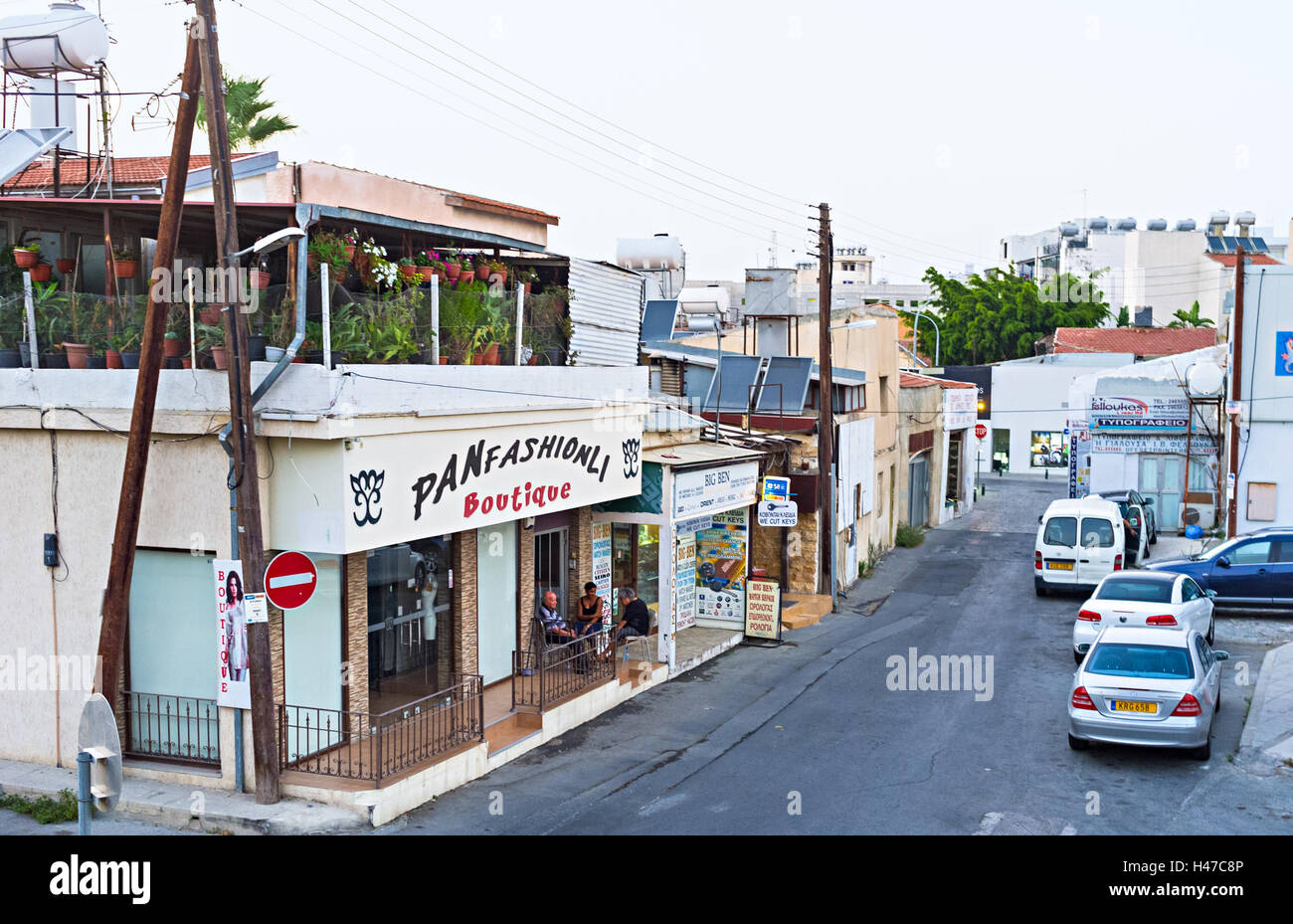 The small street of the old town with the tiny shops and car parking ...