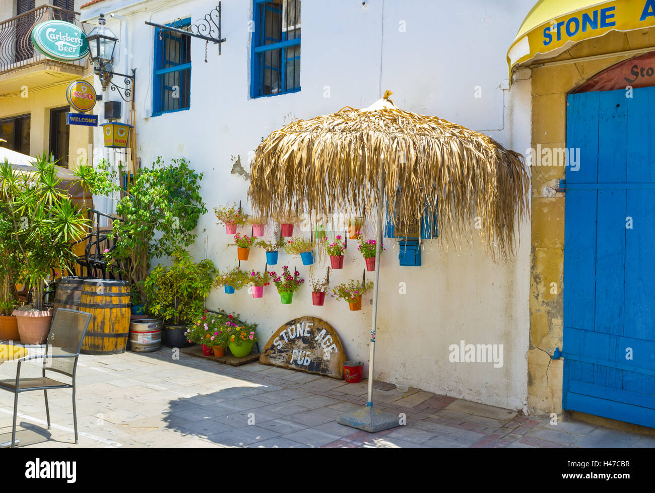 The outdoor cafe decorated with colorfull flower pots and different ...