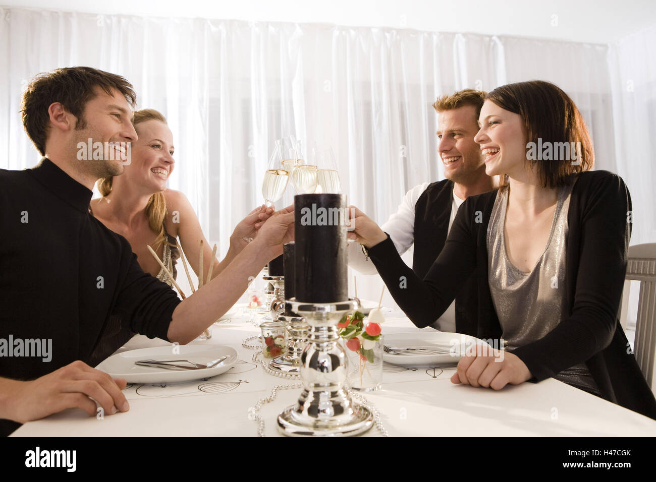 Couple, sit, cheerfully, table, champagne glasses, chink glasses Stock ...