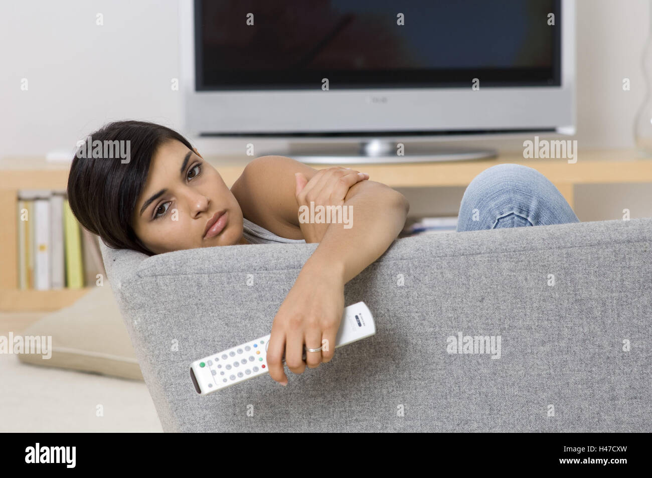 Teenager, sofa, lie, remote control, hold Stock Photo - Alamy