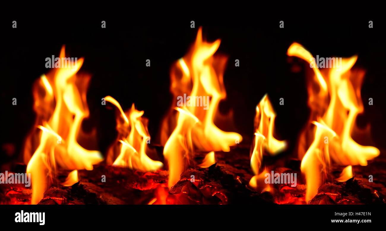 Burning and blazing flames on dark black background Stock Photo - Alamy