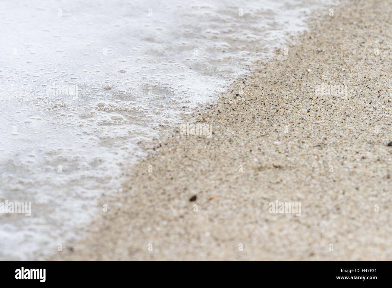shallow water moving over sand in the pacific coast of Panama as a ...