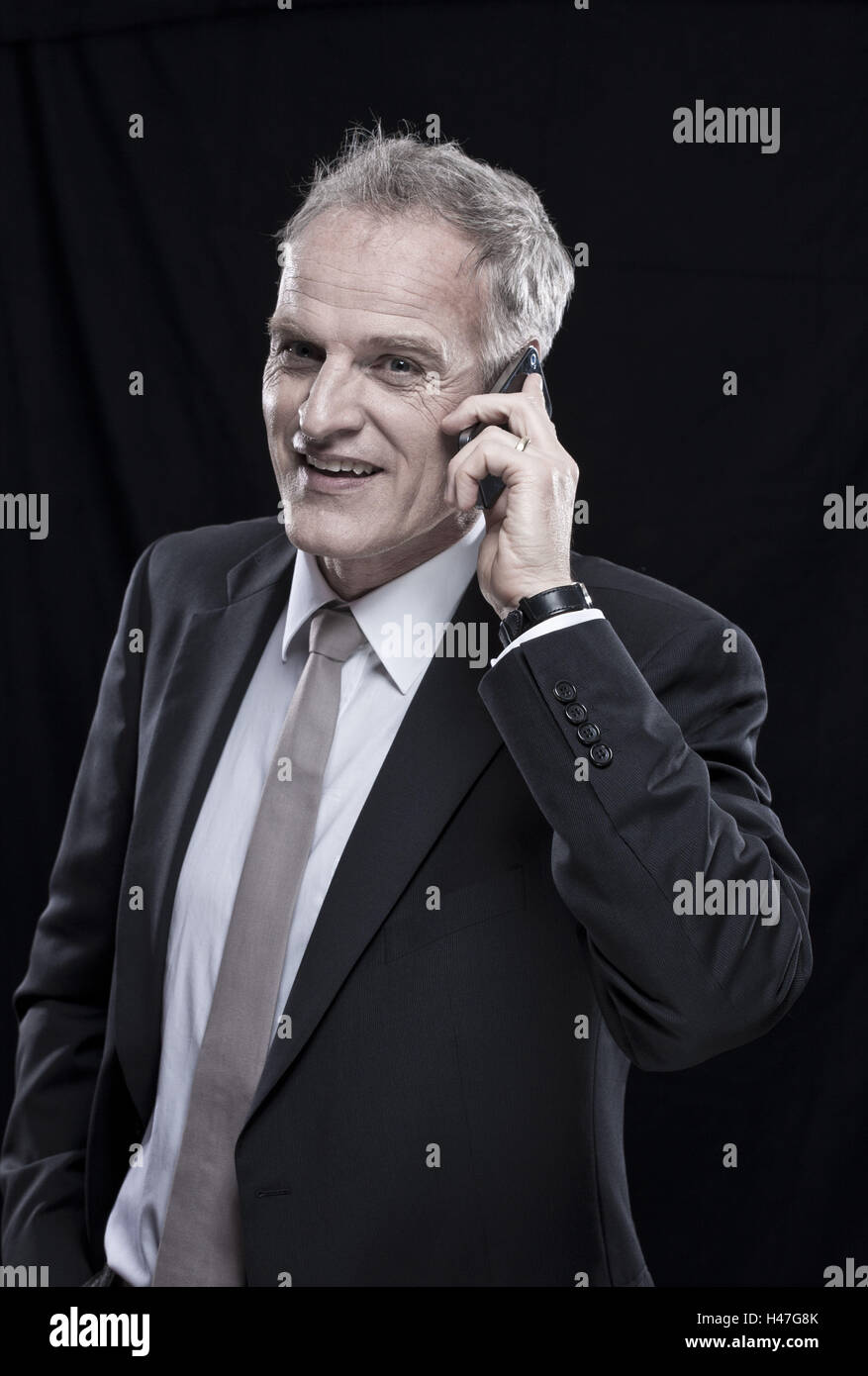 Businessman calls up mobile phone, half portrait Stock Photo - Alamy