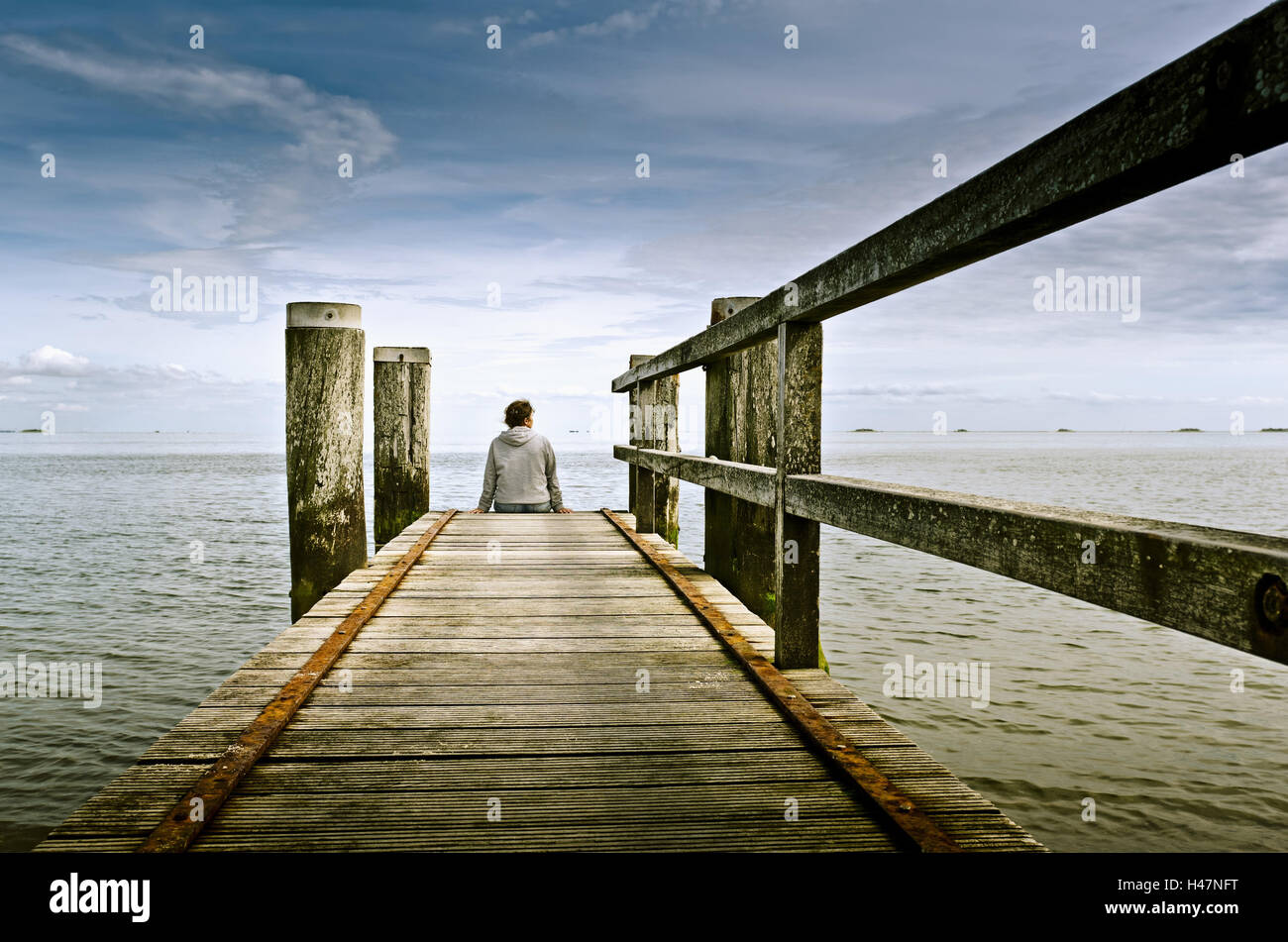 Germany, Schleswig-Holstein, Wyk, beach, woman, bridge, sitting, back ...