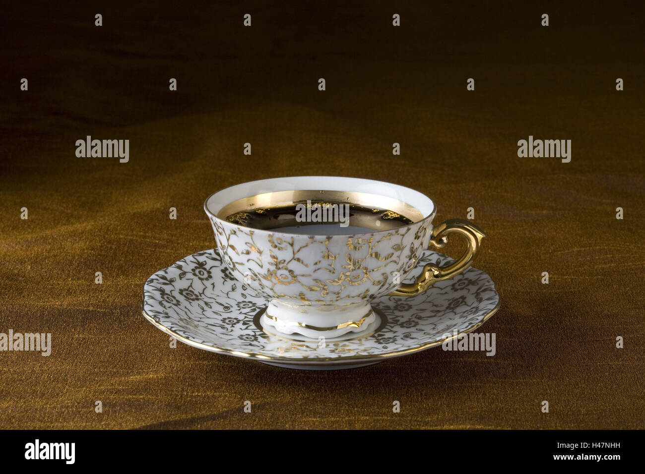 white-golden demitasse with coffee Stock Photo - Alamy