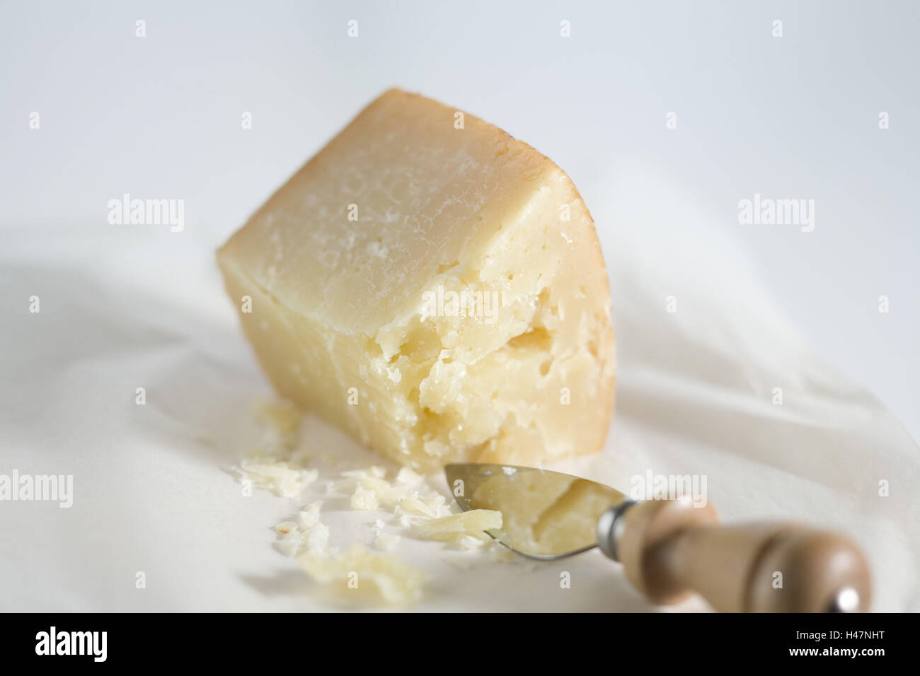 A piece parmesan cheese on paper Stock Photo - Alamy