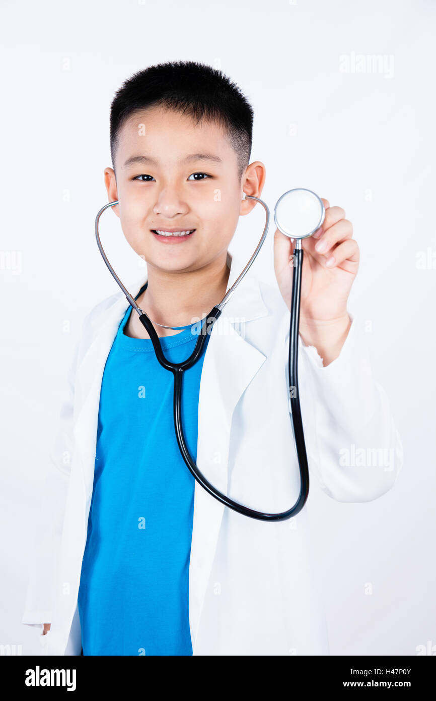Asian Chinese boy pretending as doctor with stethoscope in plain white ...