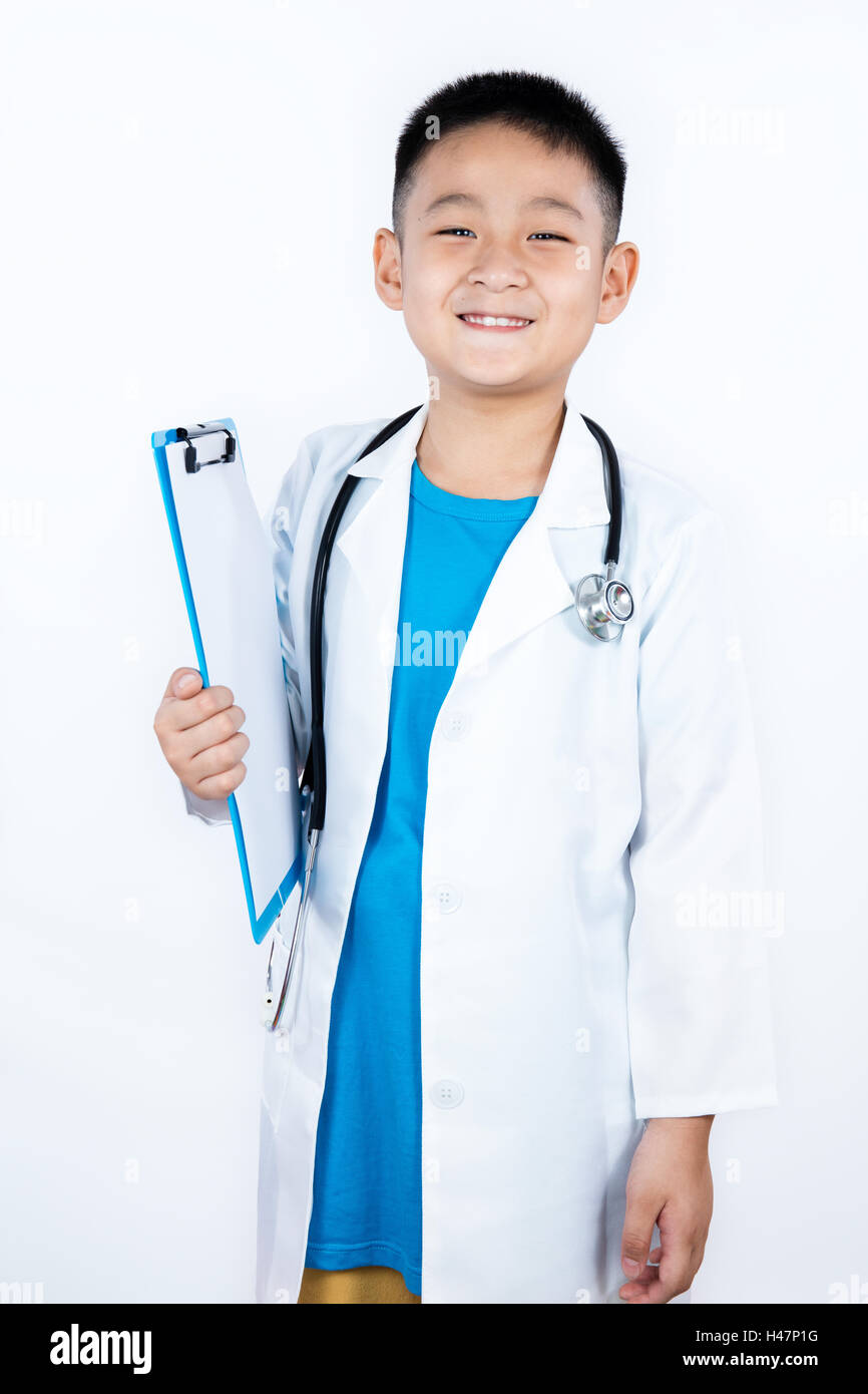 Asian Chinese boy pretending as doctor with clipboard in isolated plain ...