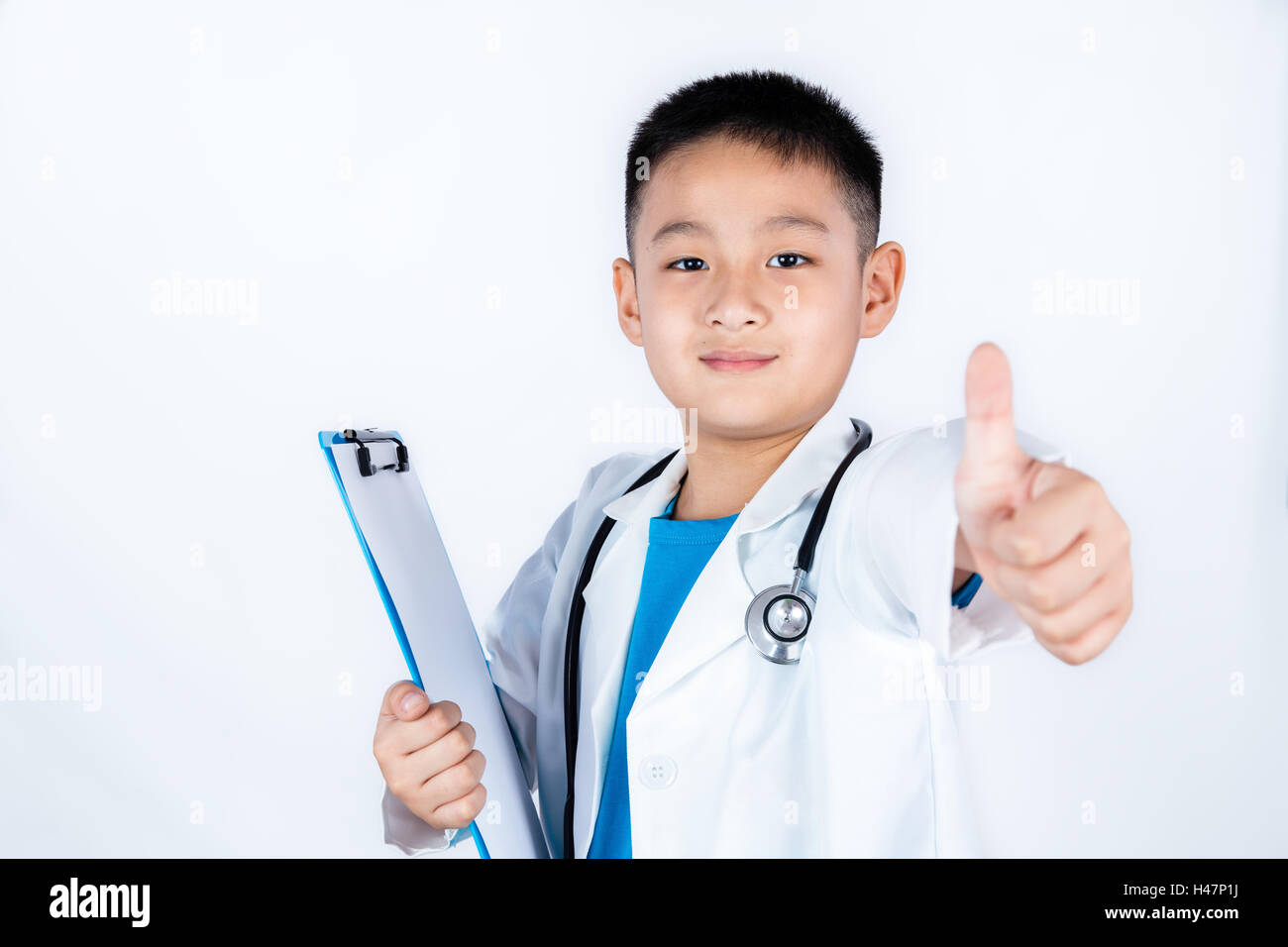 Asian Chinese boy pretending as doctor with thumbs up in isolated plain ...