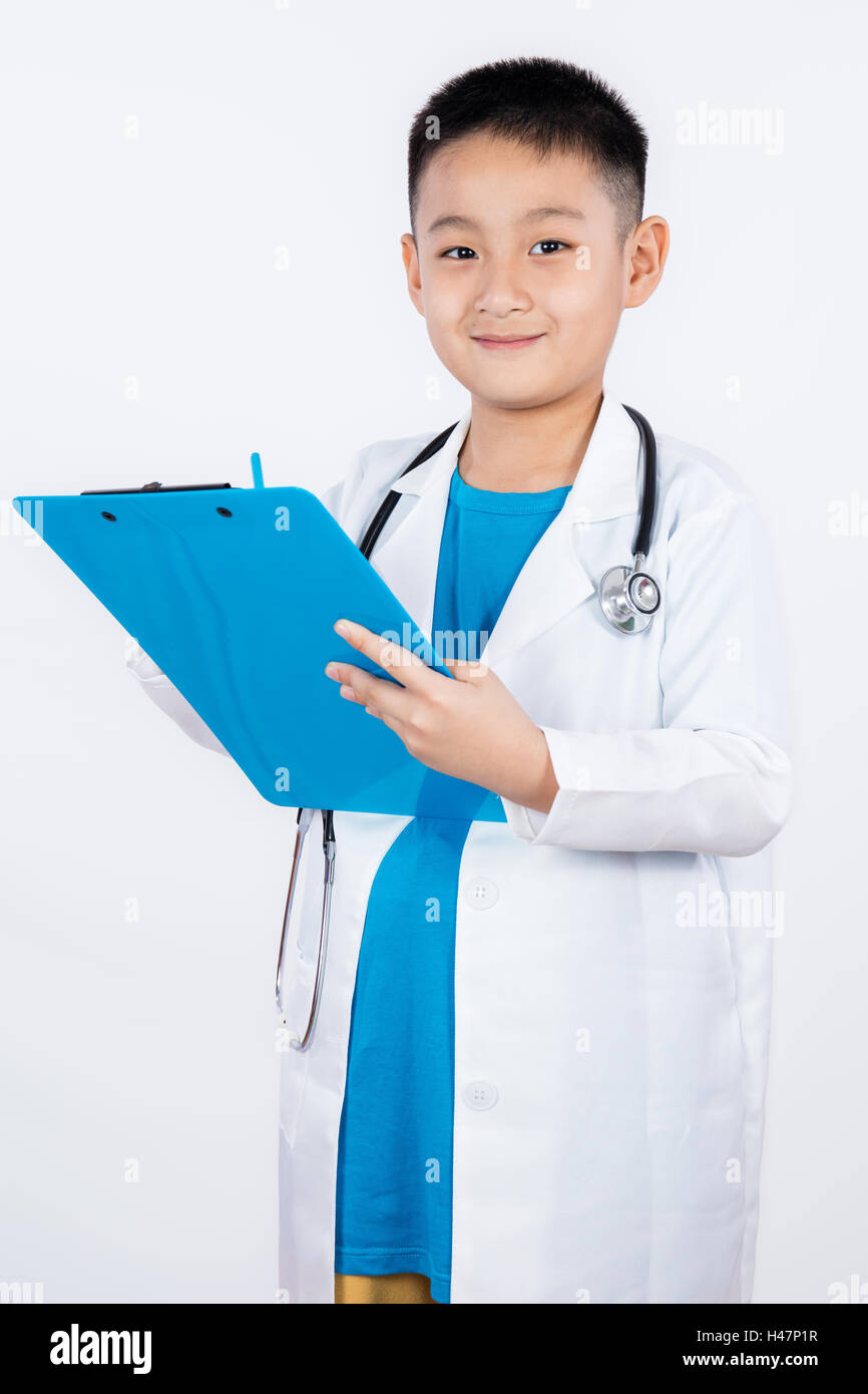 Asian Chinese boy pretending as doctor with clipboard in isolated plain ...