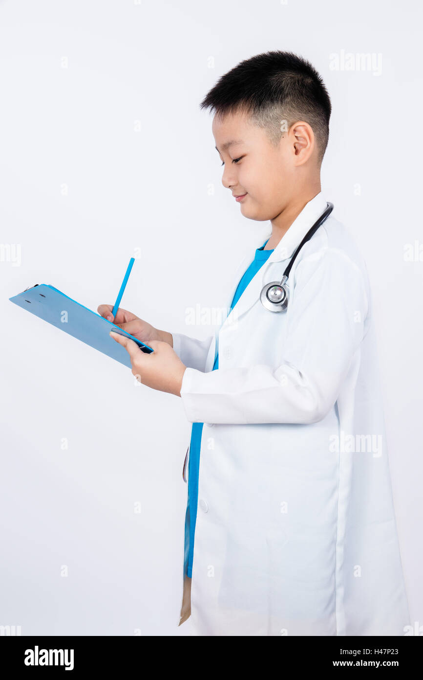 Asian Chinese boy pretending as doctor with clipboard in isolated plain ...