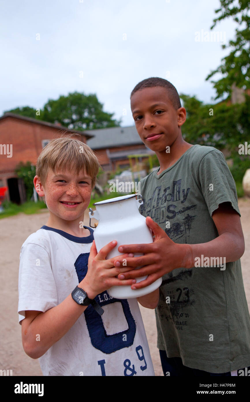 Farm, children bringing milk Stock Photo - Alamy