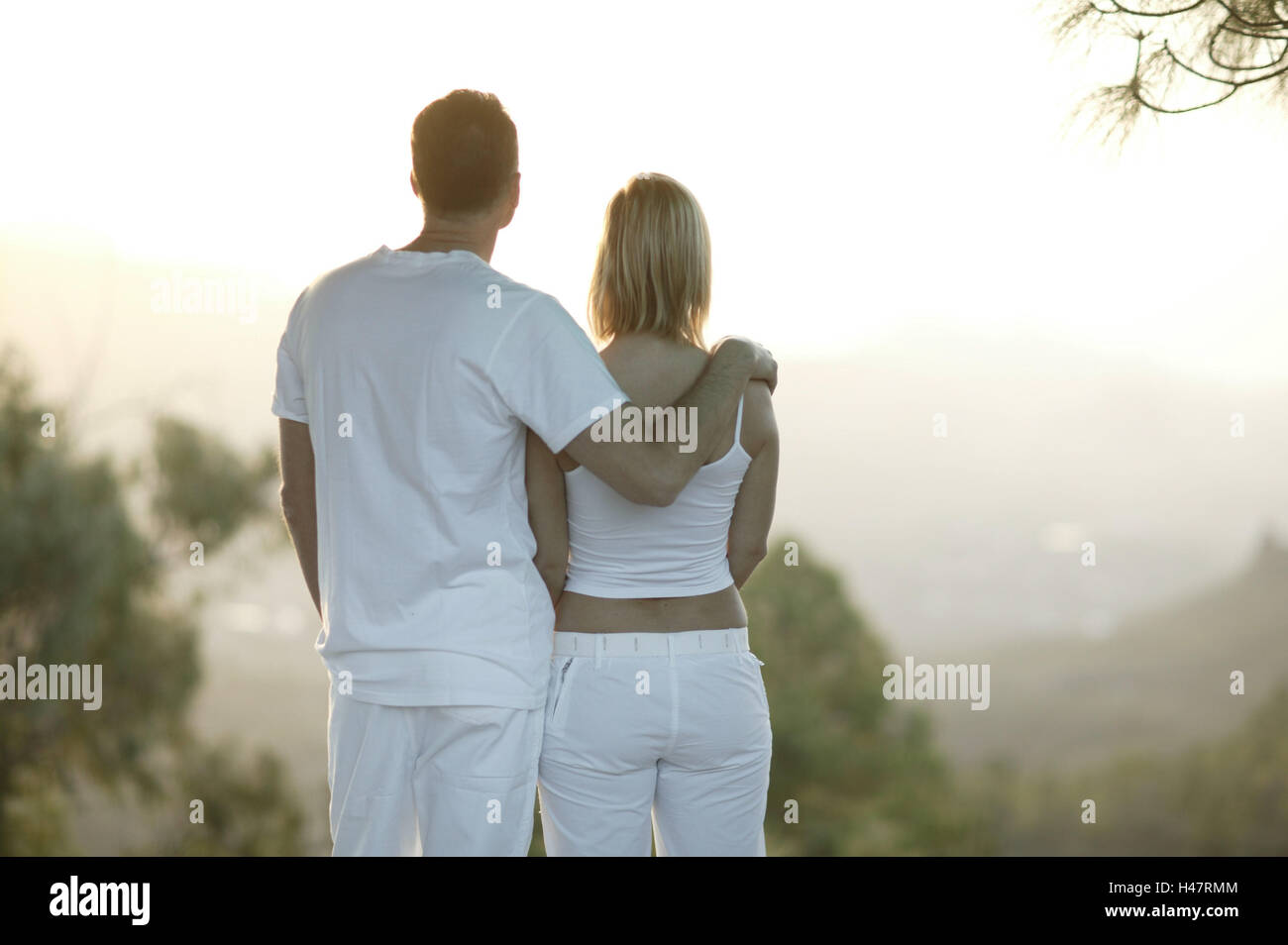 couple, standing, back view, embraces, dawn Stock Photo - Alamy