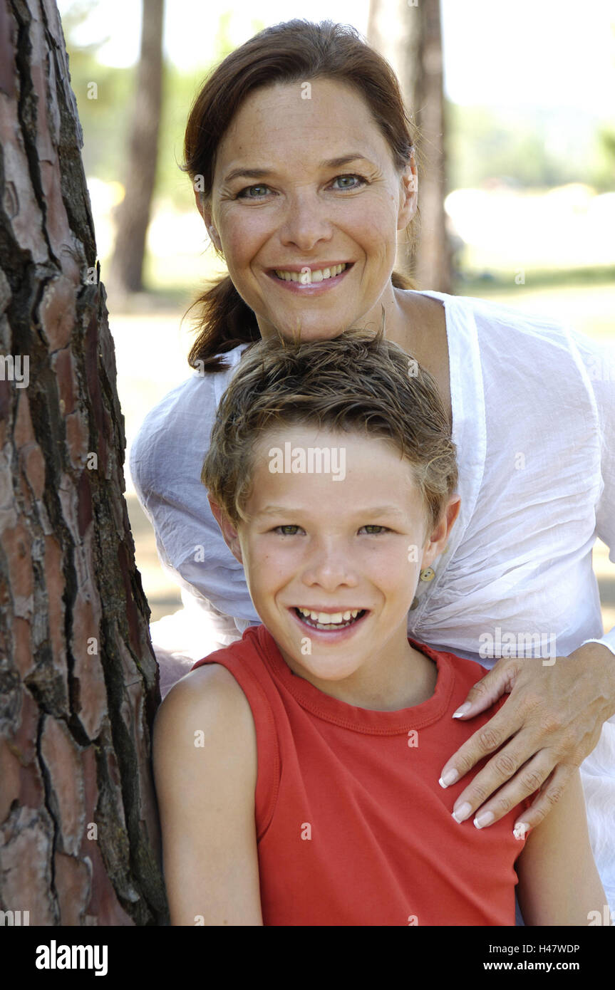 Mother, son, log, standing, joyful, smiling, gaze camera Stock Photo ...