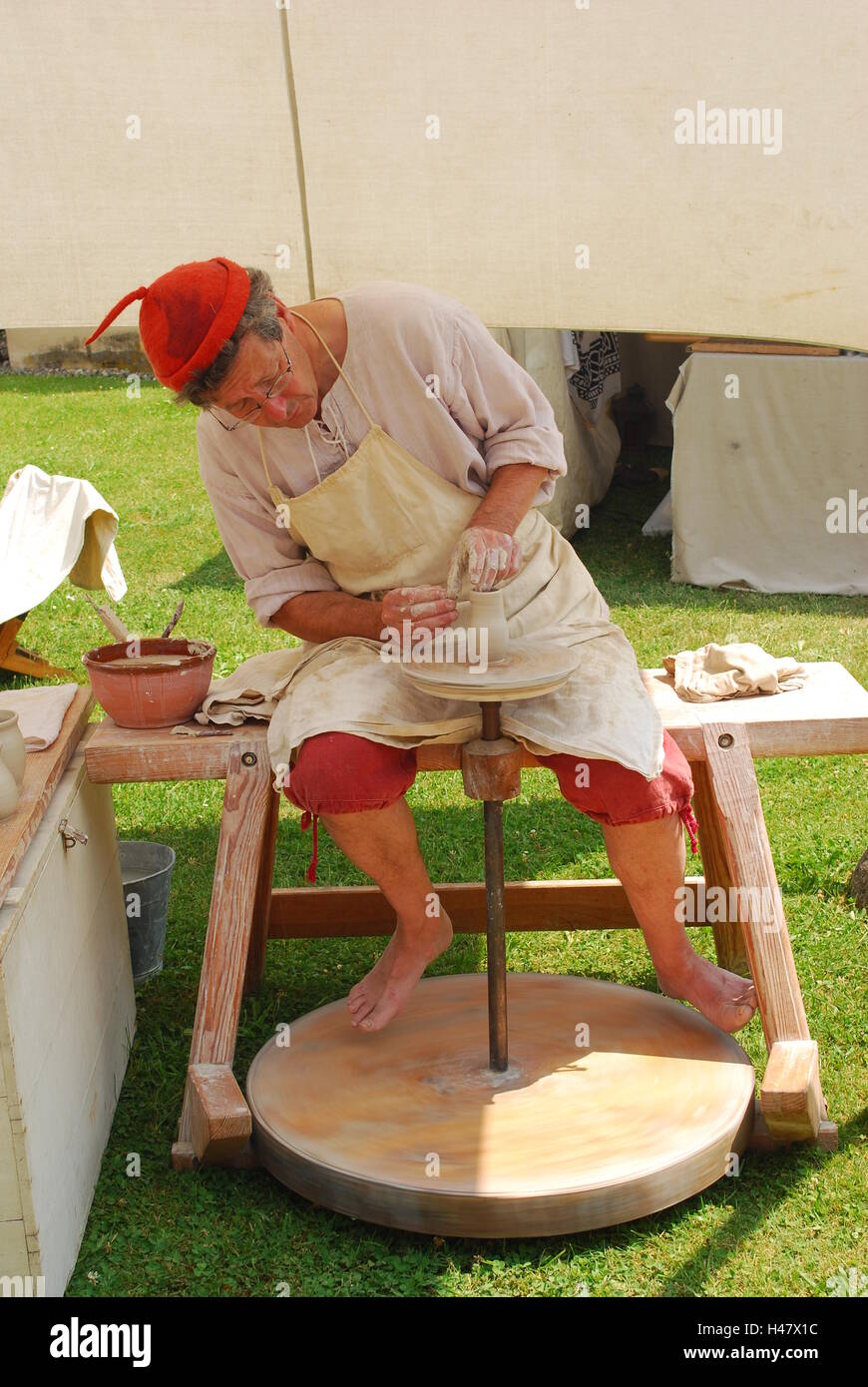 A potter dressed in a medieval costume makes a vase Stock Photo - Alamy