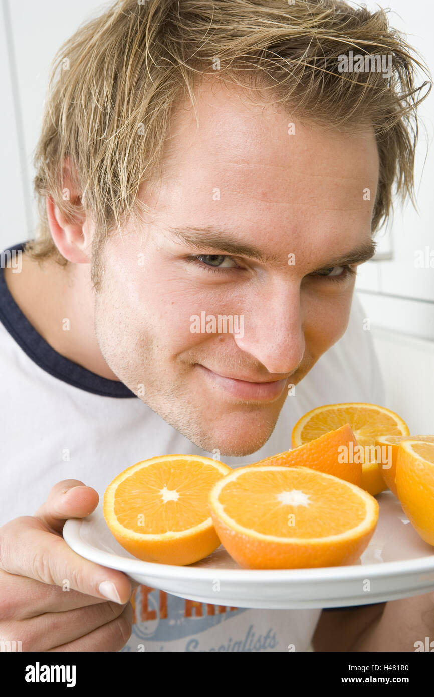 Man, plate, oranges, portrait Stock Photo - Alamy