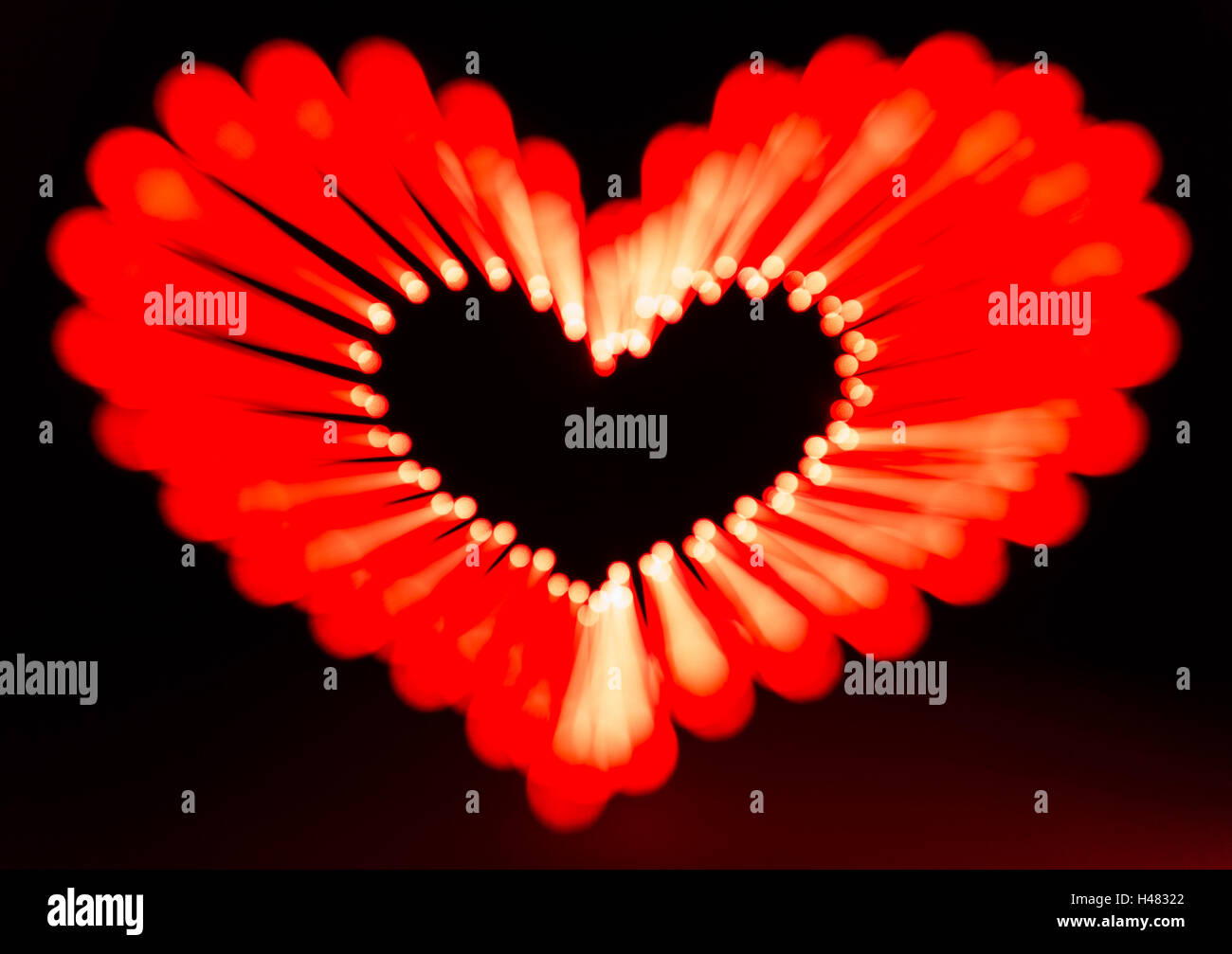 Glowing heart on dark Stock Photo - Alamy