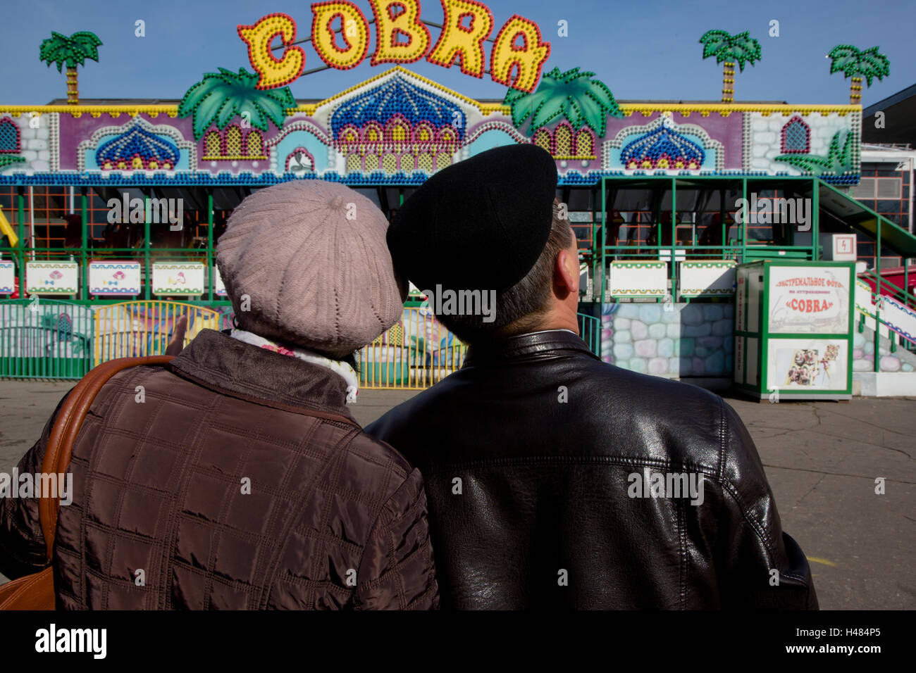 People look at the entertainment attraction "Cobra" on the territory of ...