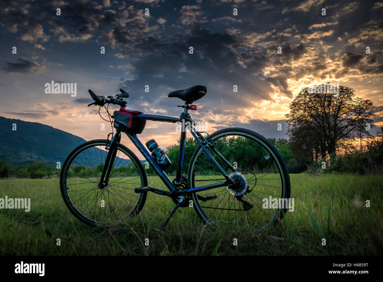 Recreation with bicycle at sunset and with dramatic sky Stock Photo - Alamy