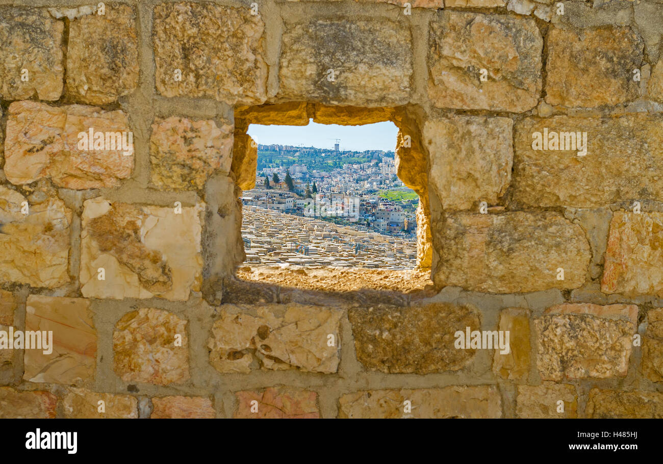 The window in old stone wall shows the old Jewish cemetery on the Mount ...